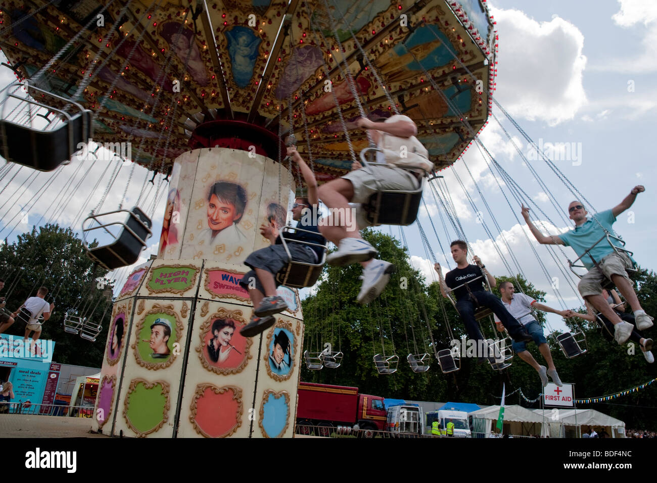 band concert crowd fun fair lake district swings tents young Stock ...
