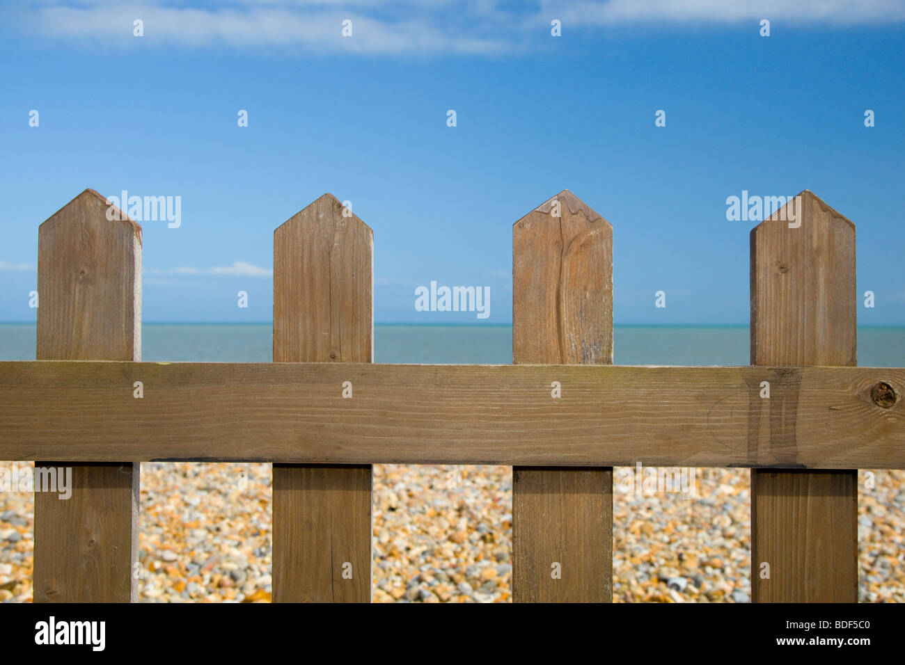A traditional fence on the beach in Brighton with the sea and the sky ...