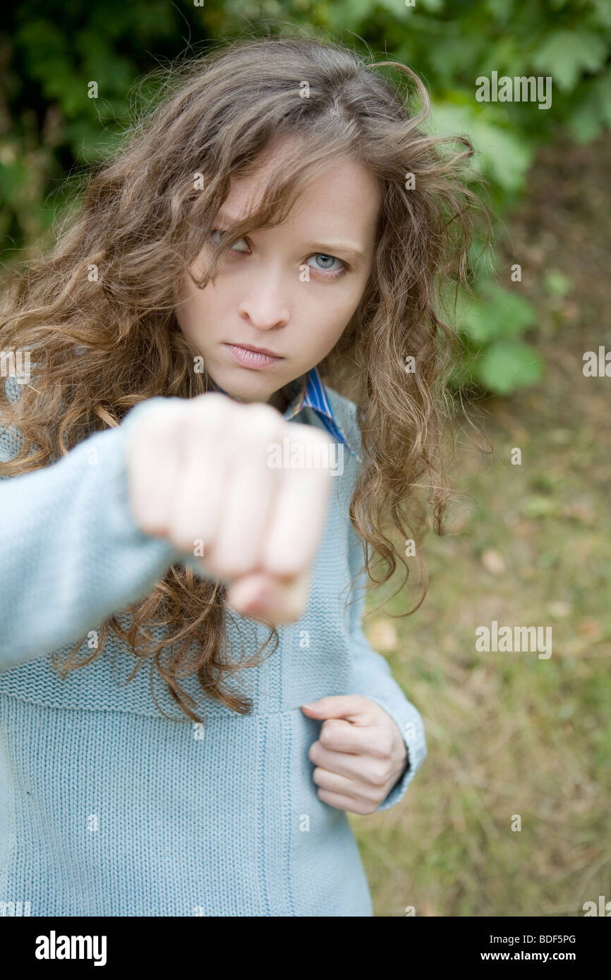 Portrait of an attractive young aggressive female punching Stock Photo ...