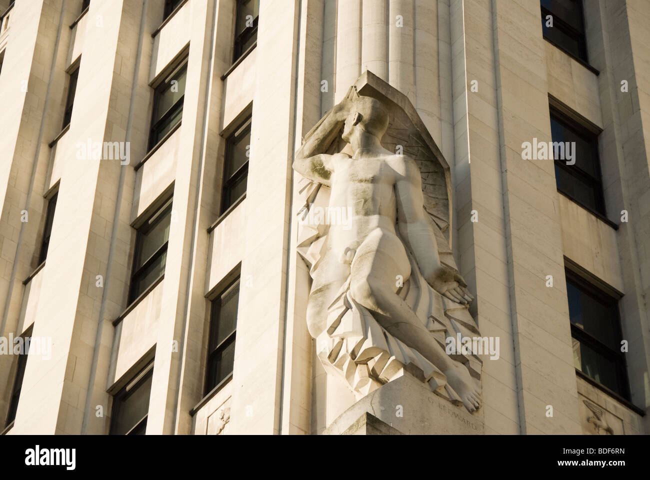 High rise building with sculpture of a male in London Stock Photo - Alamy