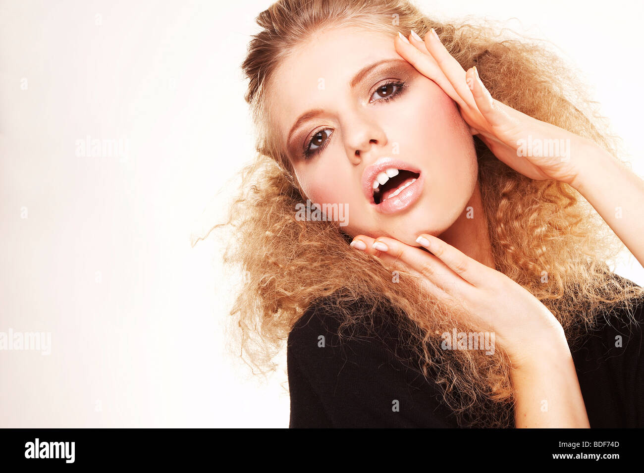 Fashion model with strong makeup posing on white background Stock Photo ...