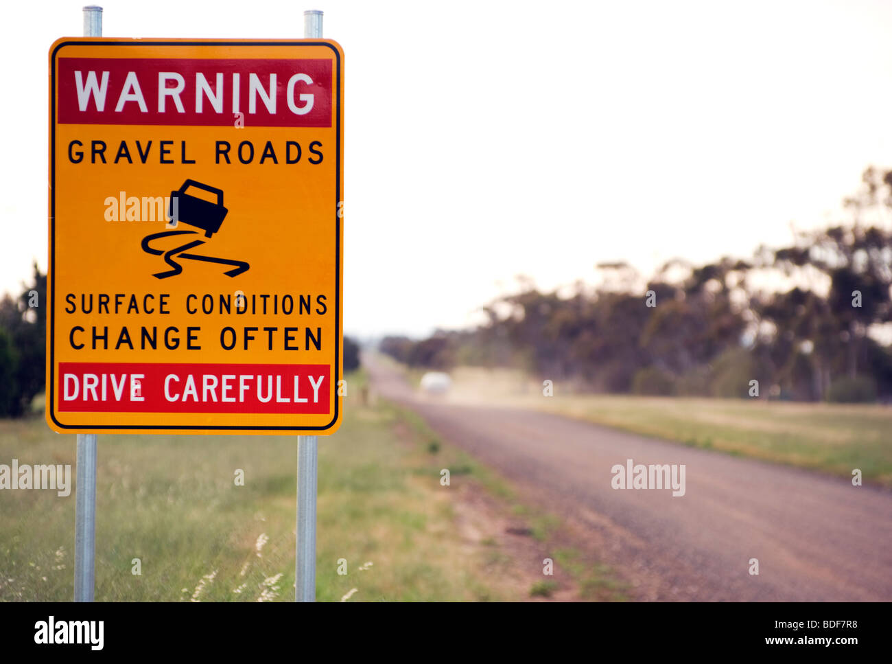 Gravel Road warning sign Stock Photo - Alamy