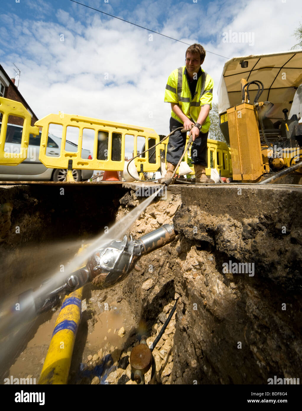 Washing mud from a boring machine drill head, laying a new gas pipe in ...