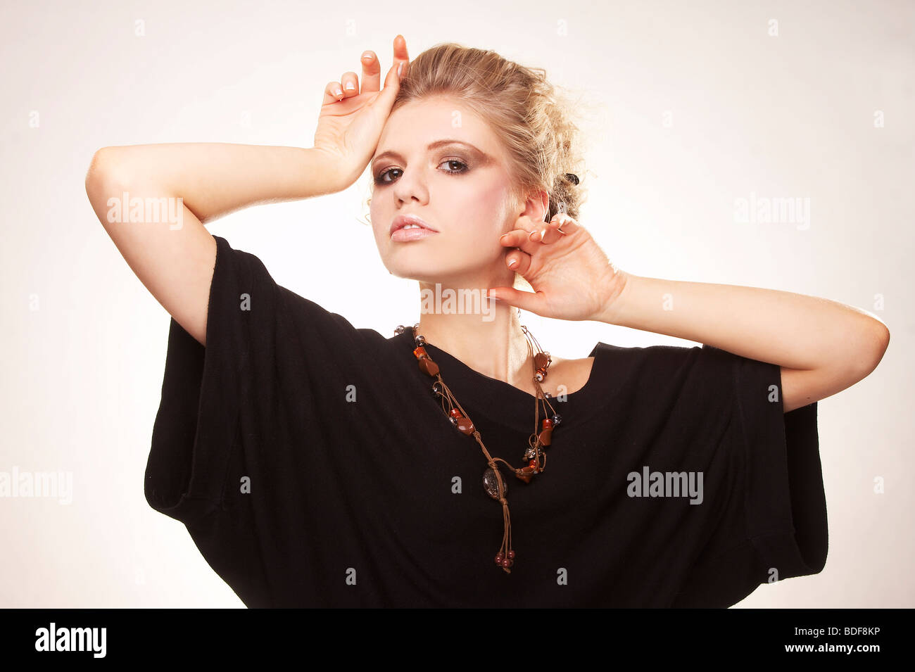 Fashion model with strong makeup posing on white background Stock Photo ...