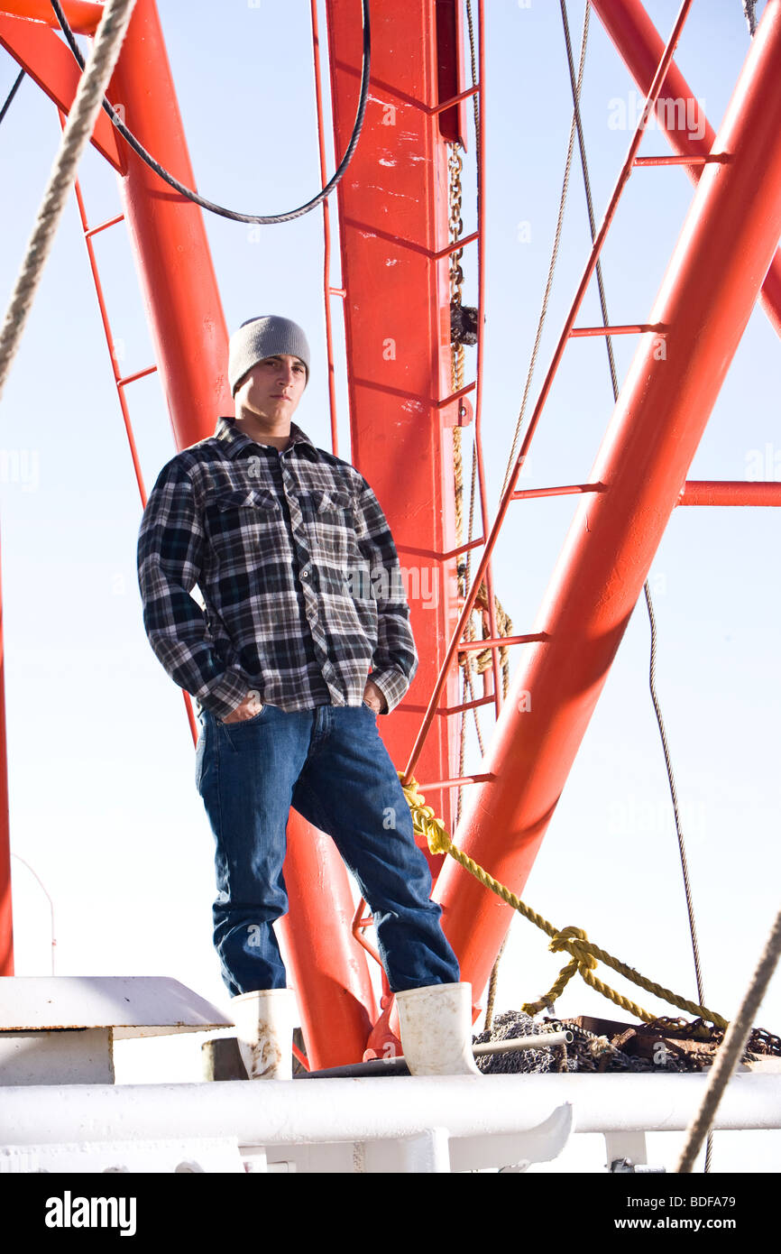 Young fisherman in plaid shirt standing on fishing boat Stock Photo - Alamy