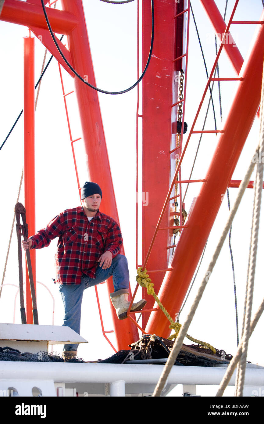 Young fisherman in plaid shirt on fishing boat Stock Photo - Alamy