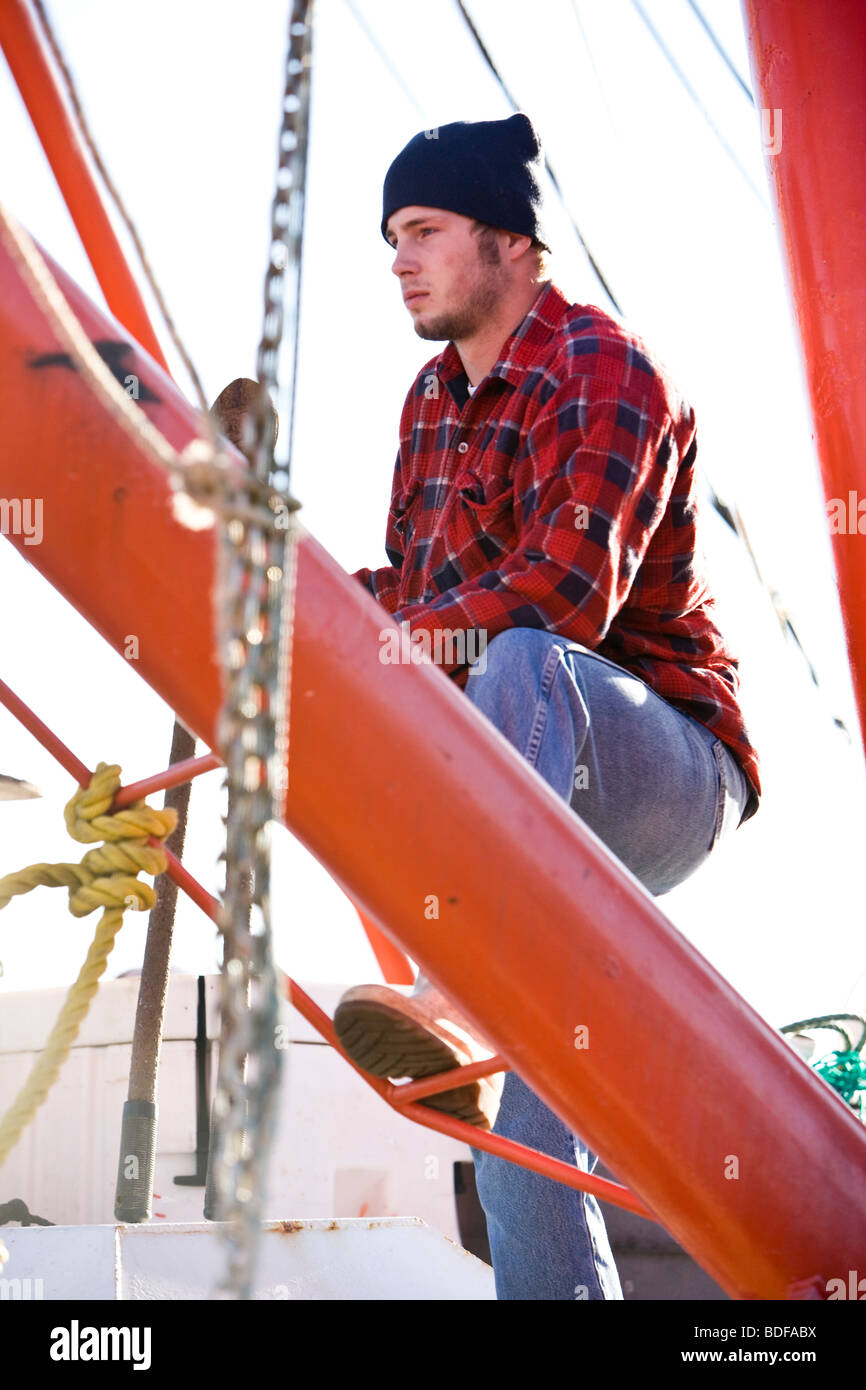 Young fisherman in plaid shirt on fishing boat Stock Photo - Alamy