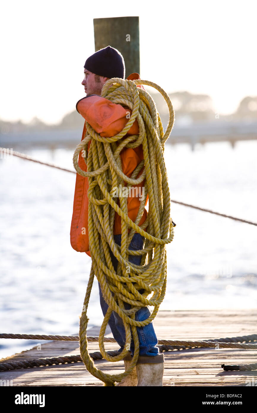 Portrait of fisherman on pier holding rope Stock Photo - Alamy