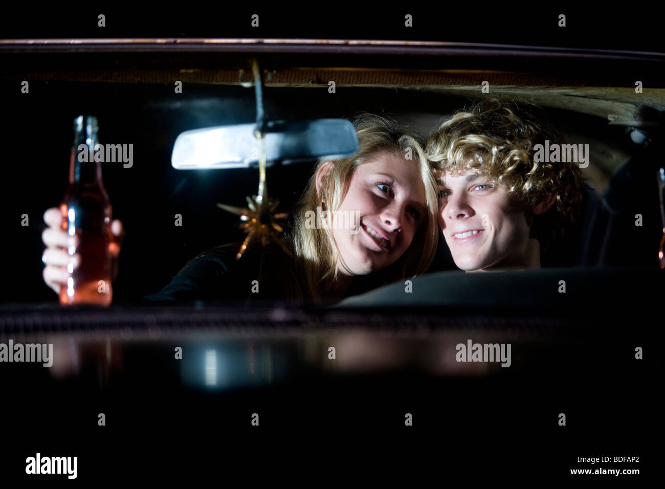 Affectionate teenage couple in car together Stock Photo - Alamy