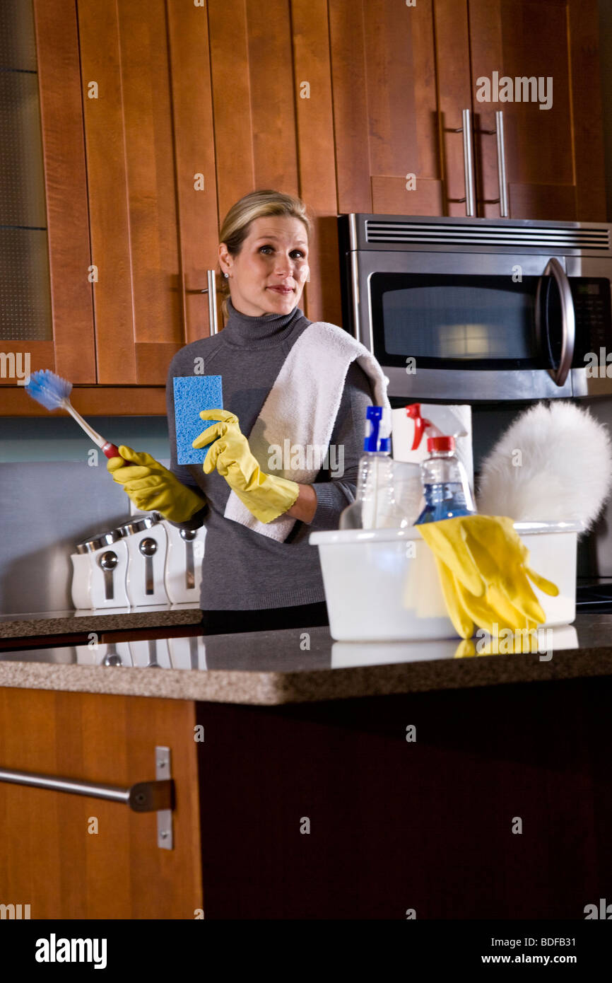 Mid-adult woman cleaning the kitchen Stock Photo - Alamy