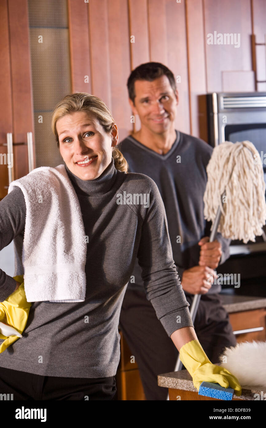 Mid-adult couple cleaning the kitchen Stock Photo - Alamy