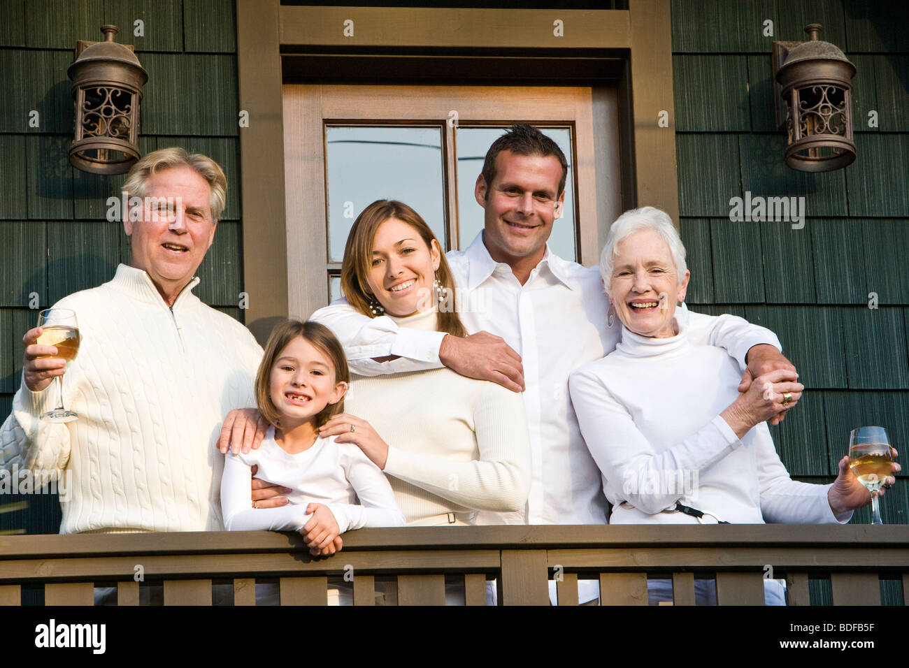 Happy multi-generational family standing on balcony Stock Photo - Alamy