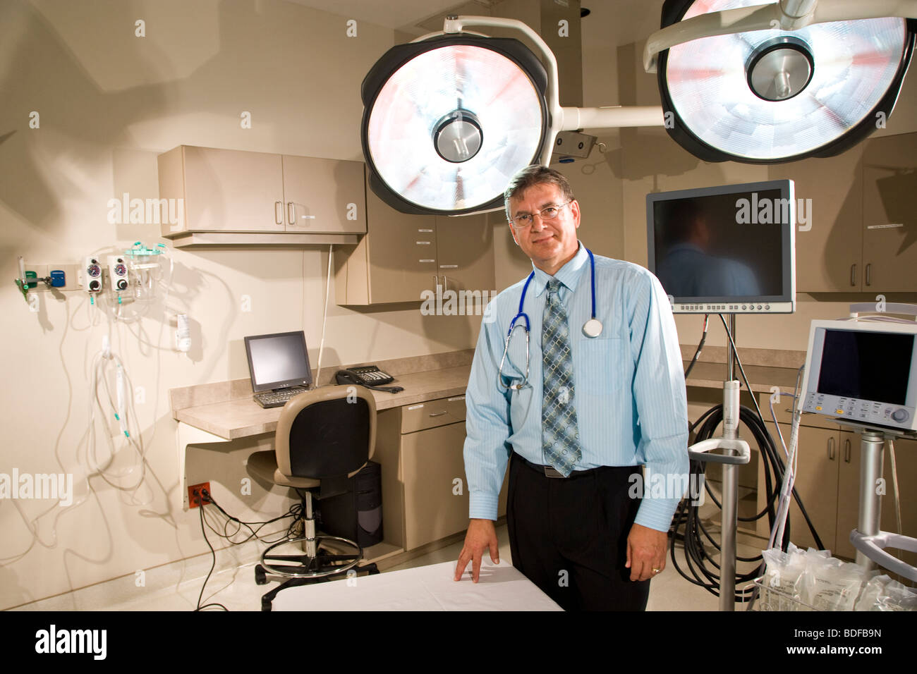 Portrait of doctor with stethoscope in hospital room with surgical ...