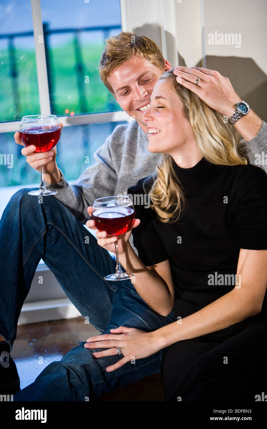 Young couple drinking wine together Stock Photo - Alamy