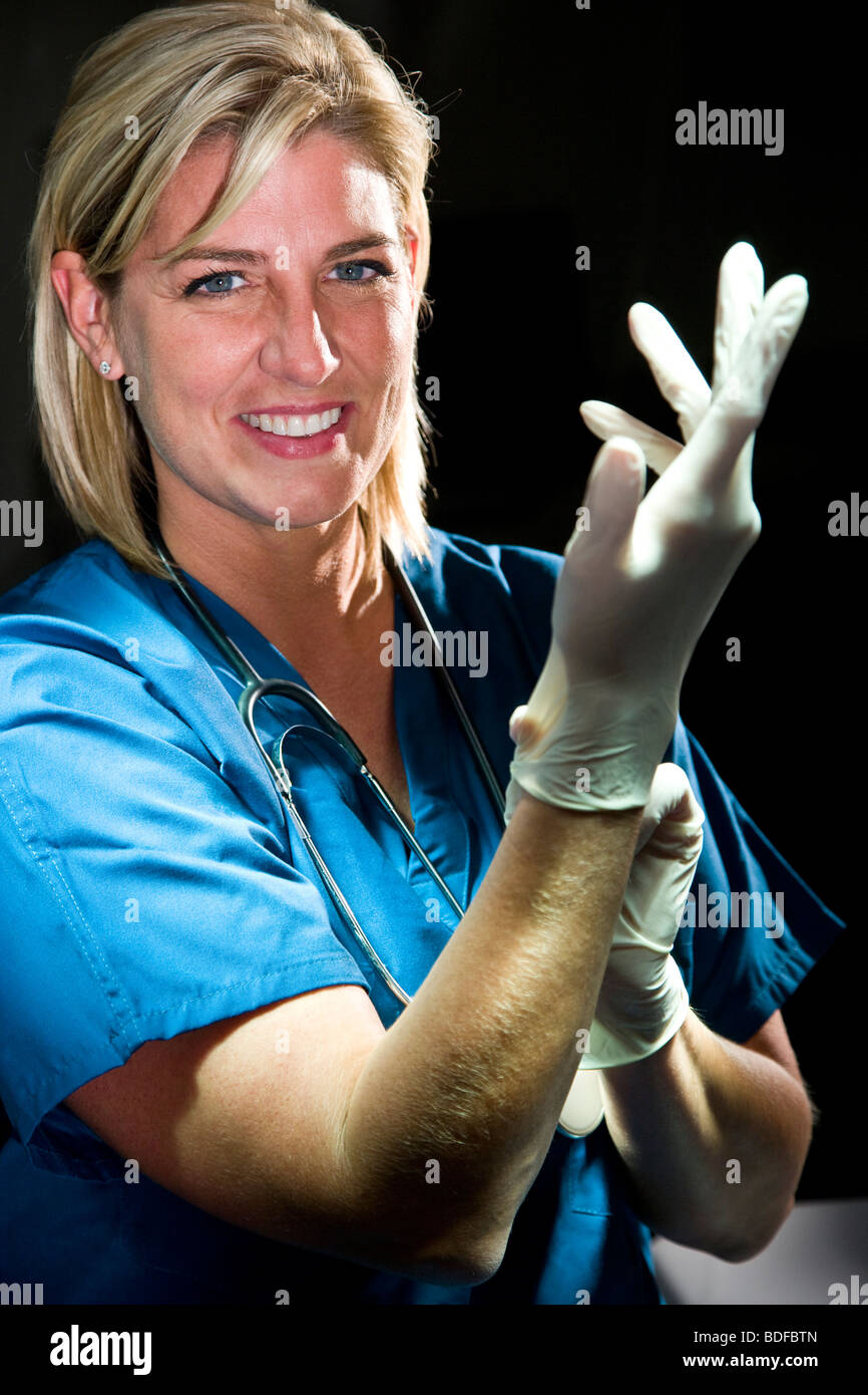 Female doctor putting on surgical gloves Stock Photo - Alamy