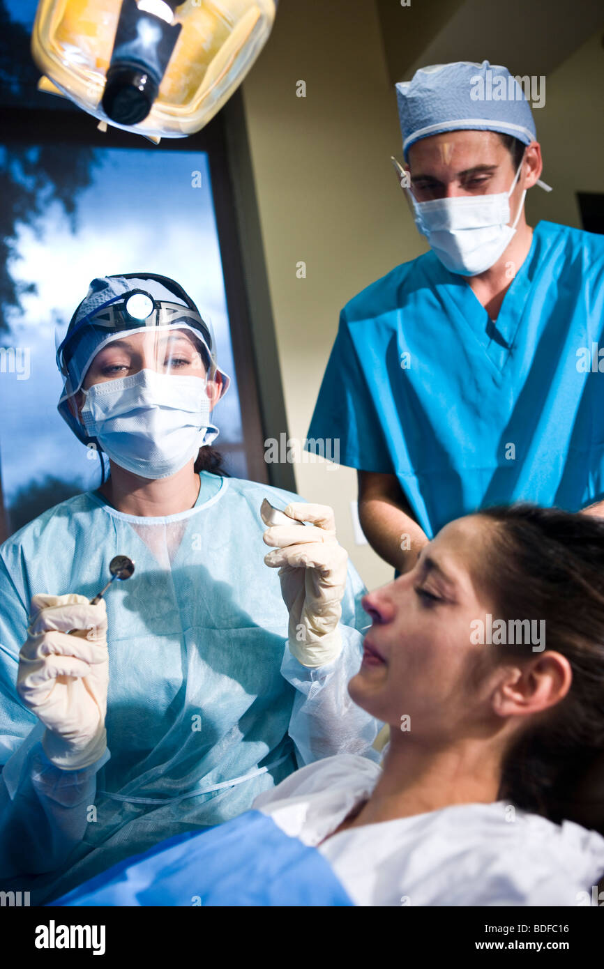 Healthcare workers about to work on nervous patient Stock Photo - Alamy