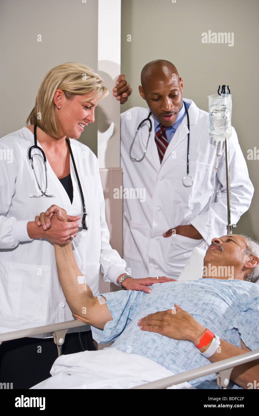 Portrait multi ethnic doctors comforting patient hi-res stock ...