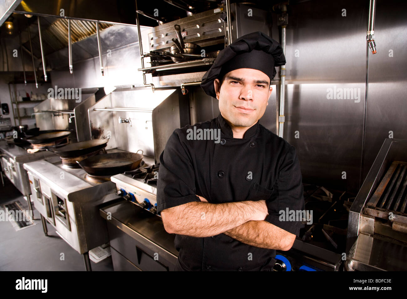 Professional chef standing in restaurant kitchen Stock Photo - Alamy