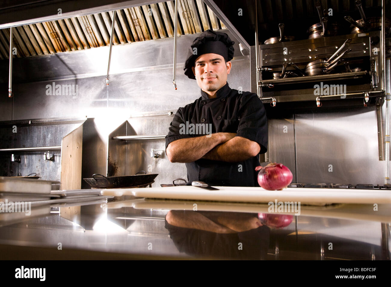 Professional chef standing in restaurant kitchen Stock Photo - Alamy