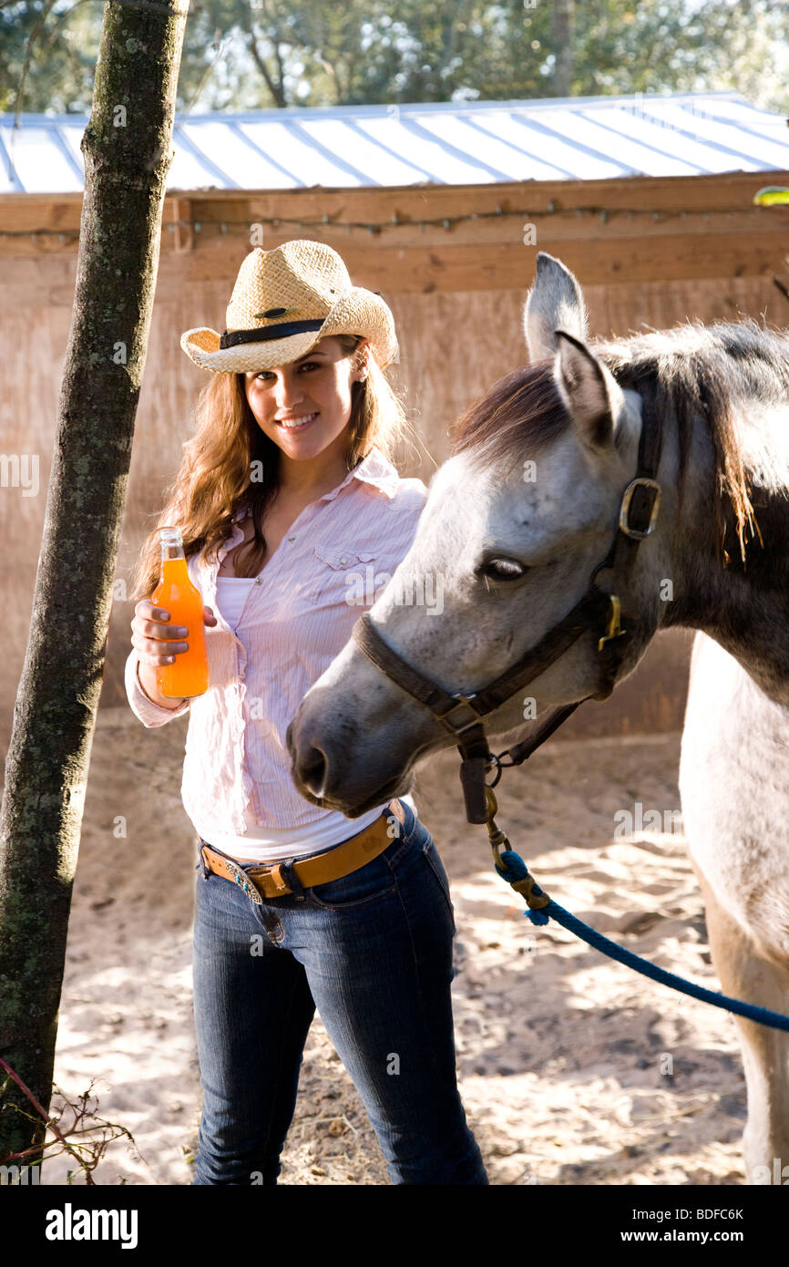 Young woman with white Gelding horse on farm Stock Photo - Alamy