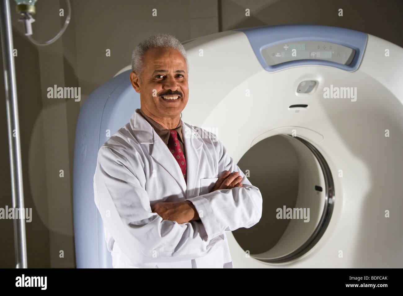 African American radiologist next to CT scanner Stock Photo - Alamy