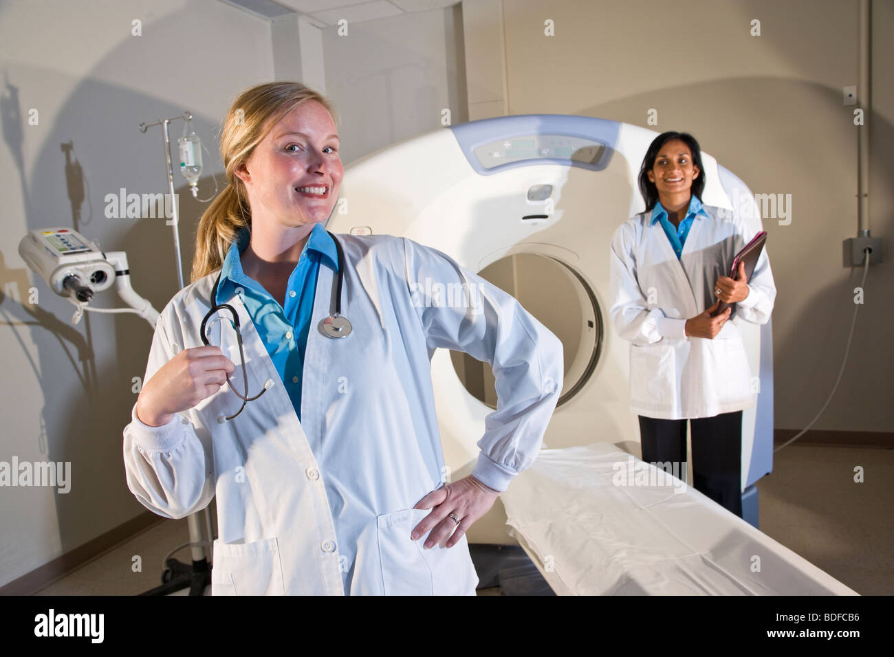 Healthcare workers standing next to CAT scan machine Stock Photo - Alamy