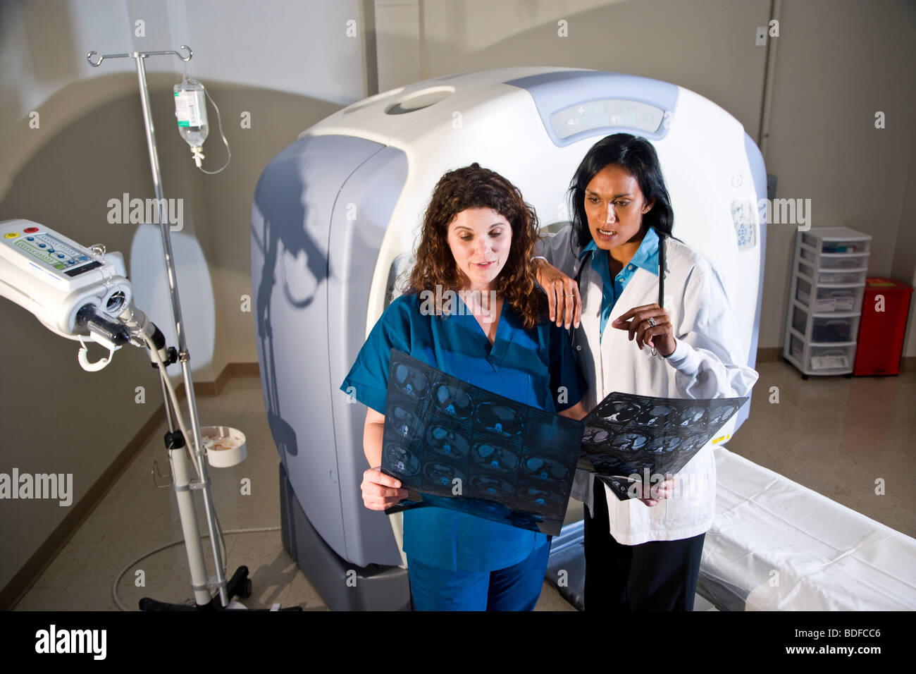 Two healthcare workers looking over results of CAT scan Stock Photo - Alamy