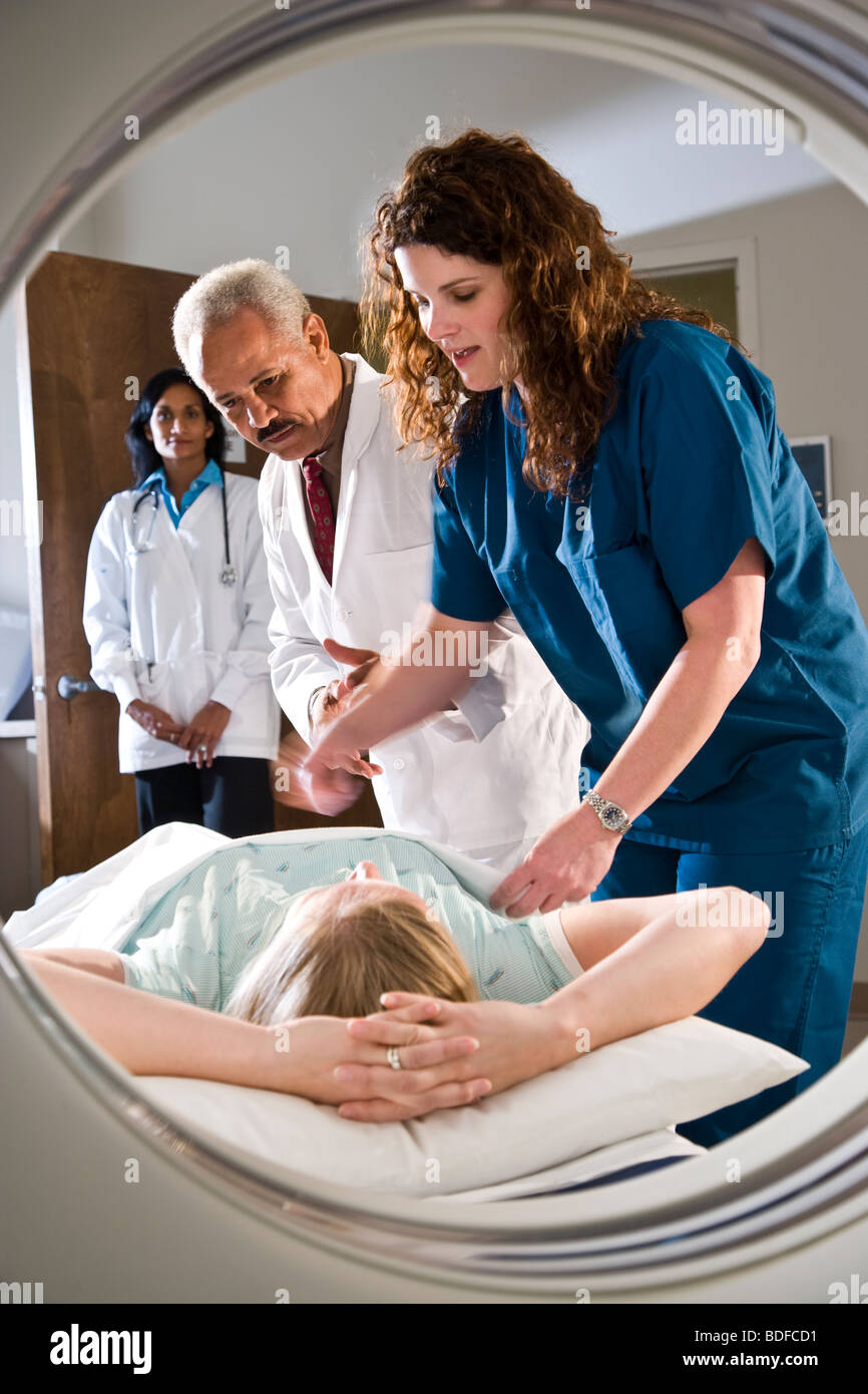 Healthcare workers preparing patient for CAT scan Stock Photo - Alamy
