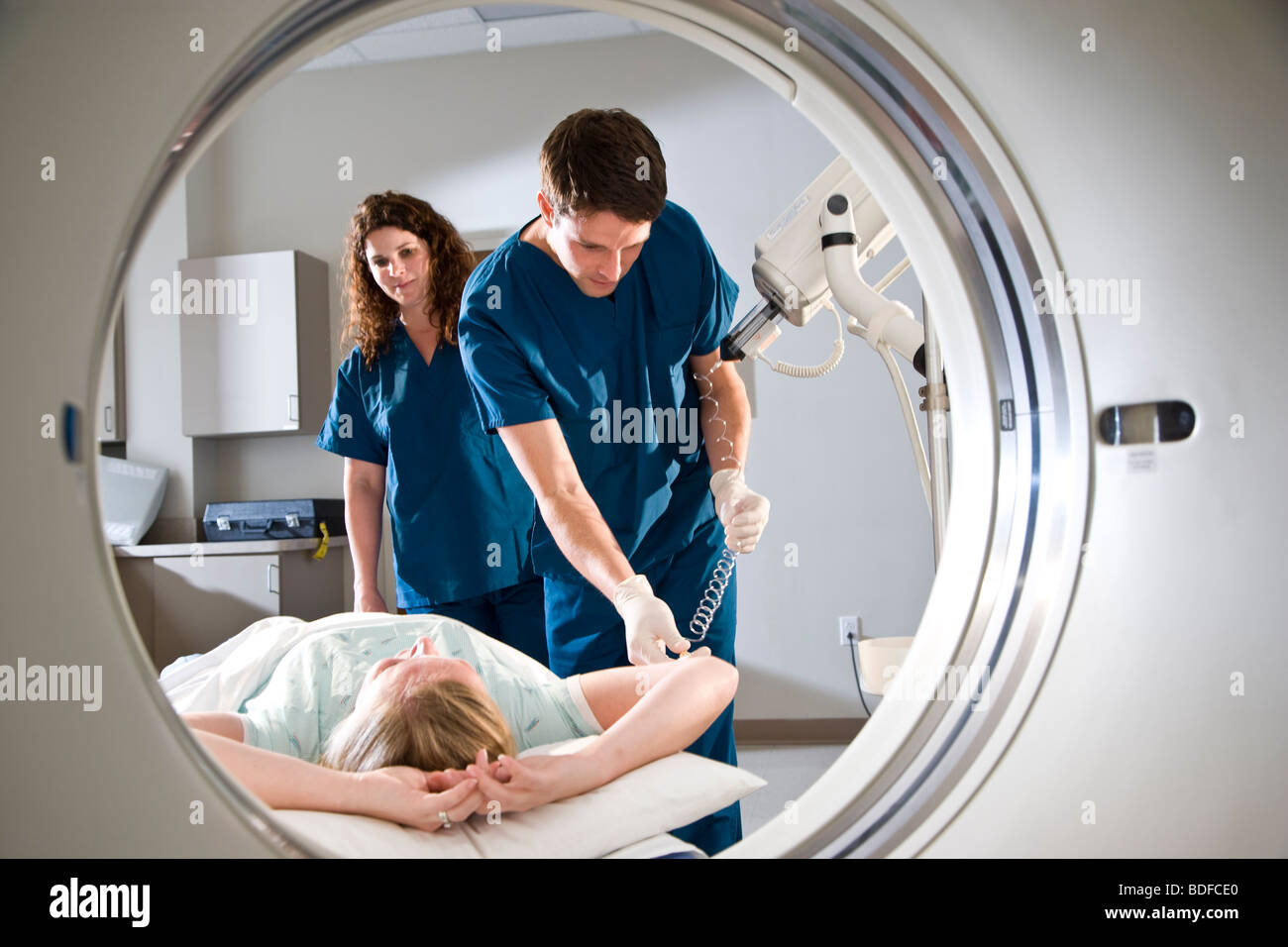 Healthcare workers preparing patient for CAT scan Stock Photo - Alamy