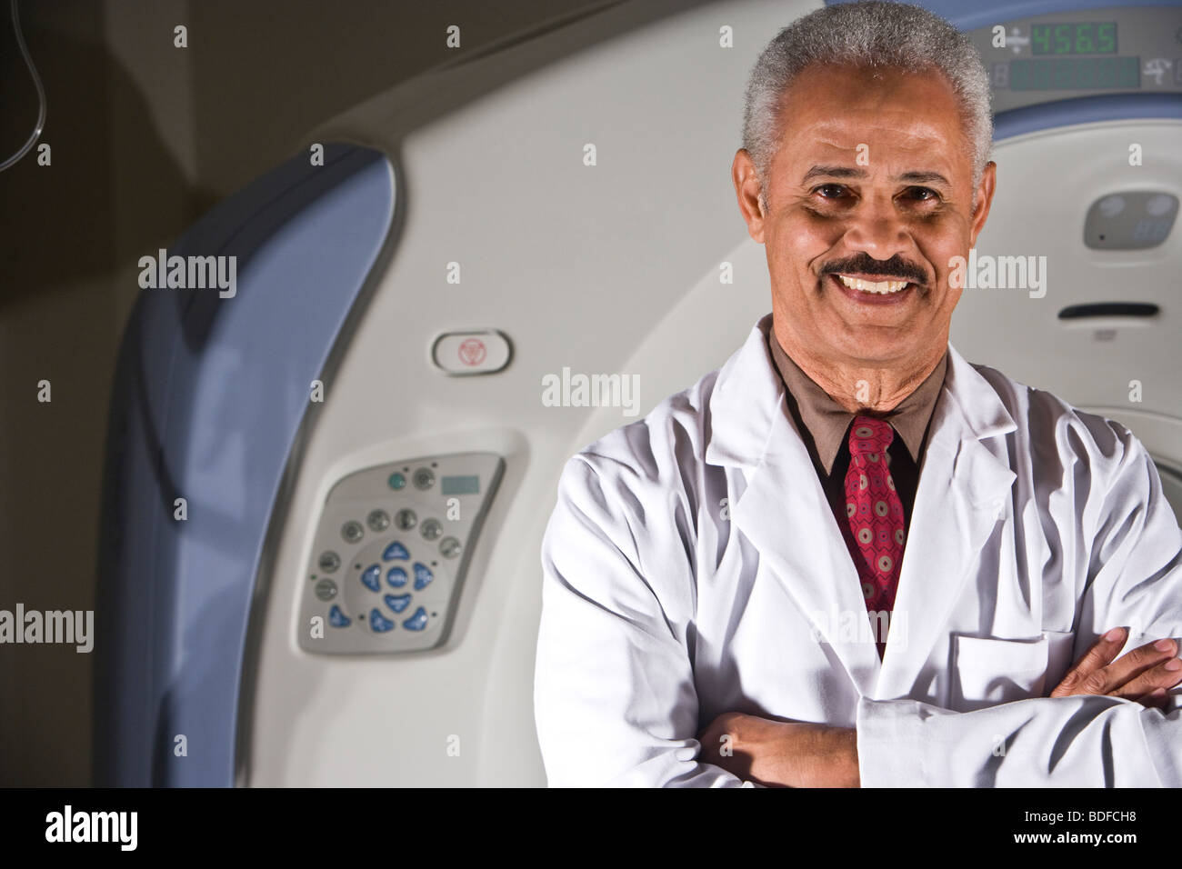 African American radiologist next to CAT scan machine Stock Photo - Alamy