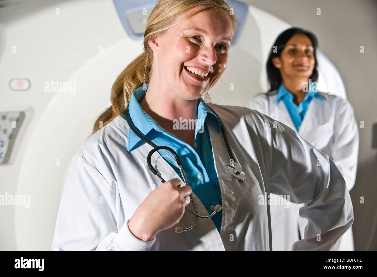 Healthcare workers standing next to CAT scan machine Stock Photo - Alamy