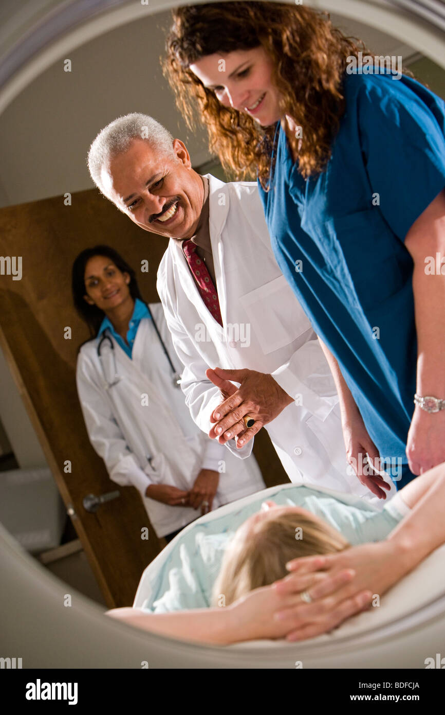 Healthcare workers preparing patient for CAT scan Stock Photo - Alamy