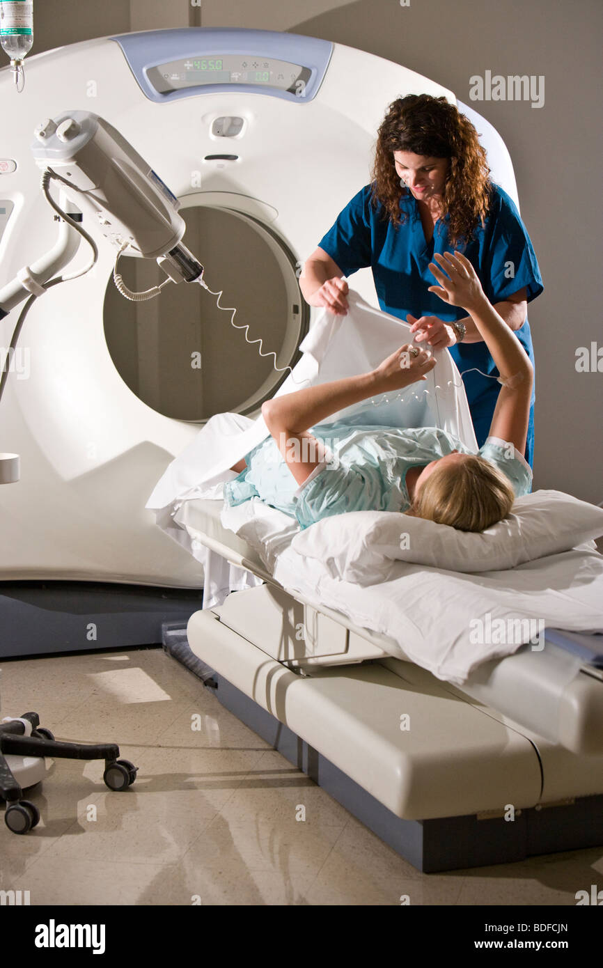 Healthcare worker preparing patient for CAT scan Stock Photo - Alamy