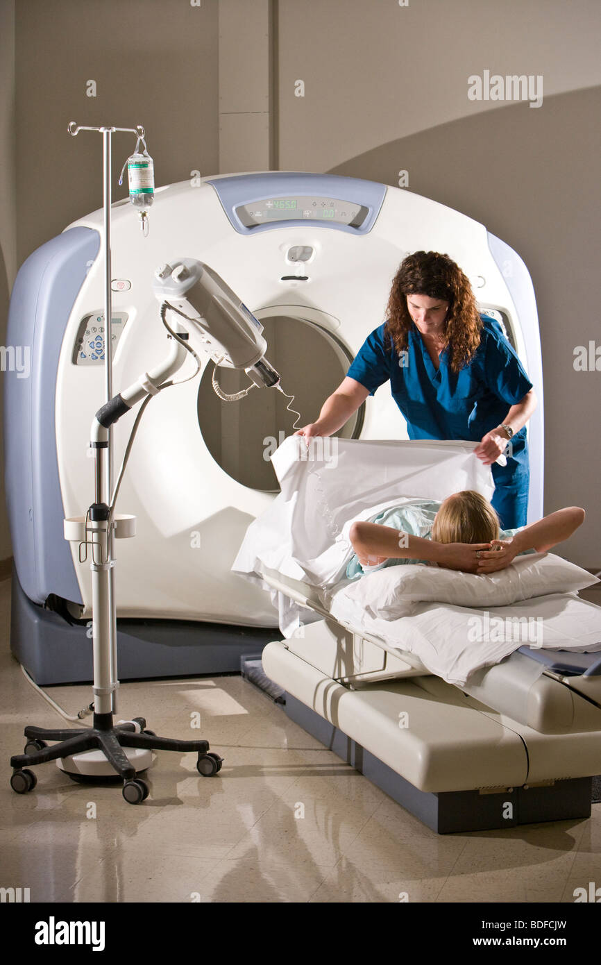 Healthcare worker preparing patient for CAT scan Stock Photo - Alamy