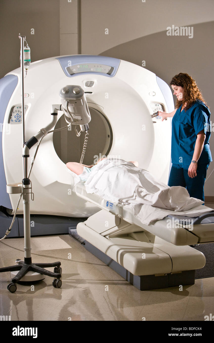 Healthcare worker preparing patient for CAT scan Stock Photo - Alamy