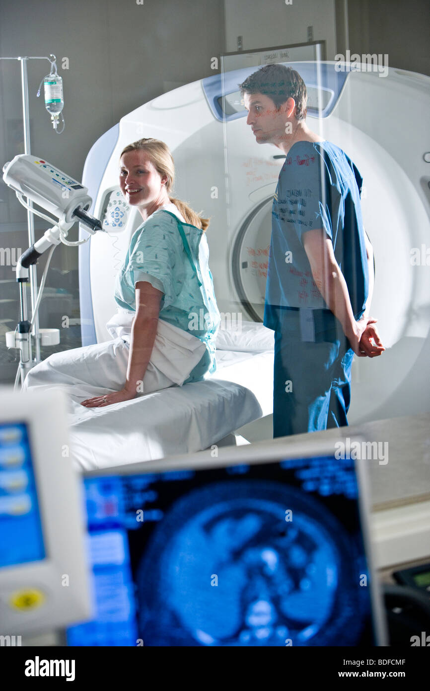 Healthcare worker preparing patient for CAT scan Stock Photo - Alamy