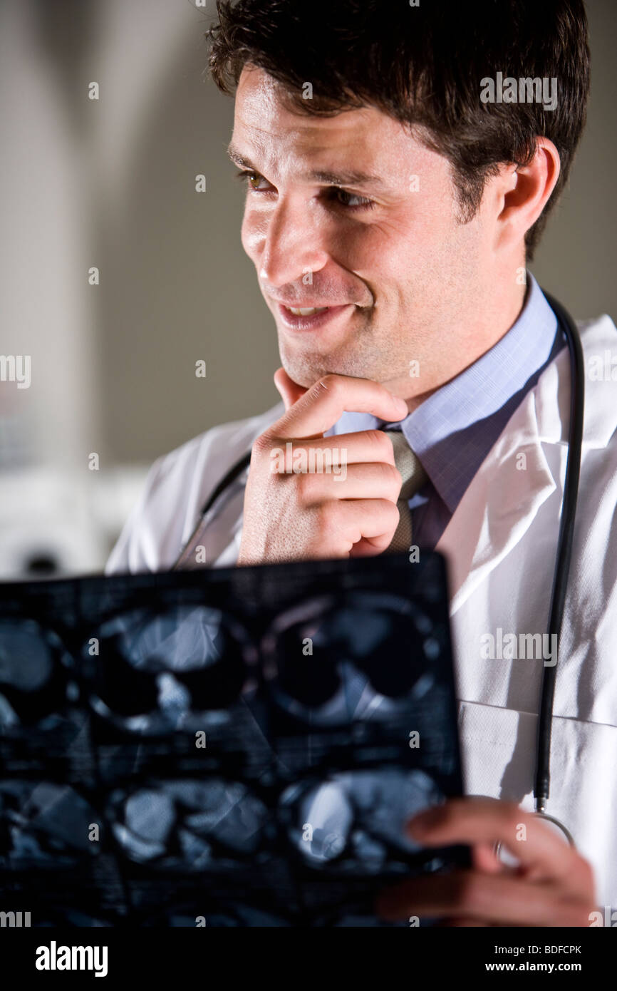 Doctor holding up a CT scan Stock Photo - Alamy