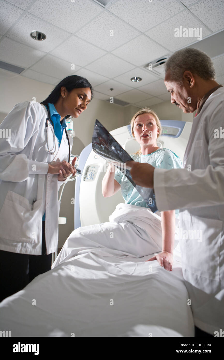 Doctors reviewing CT scan results with patient Stock Photo - Alamy