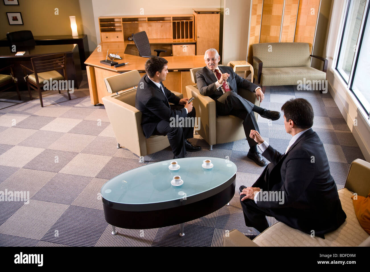 Hispanic businessmen talking in office Stock Photo - Alamy