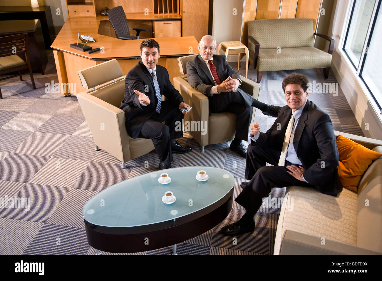 Hispanic businessmen talking in office Stock Photo - Alamy