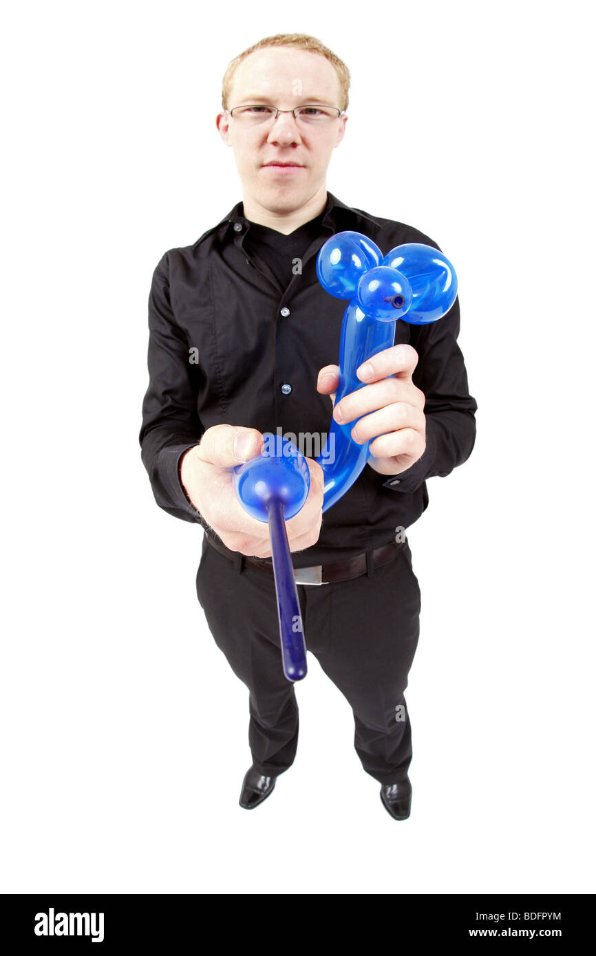 young magic tinkering a balloon animal with balloons Stock Photo - Alamy