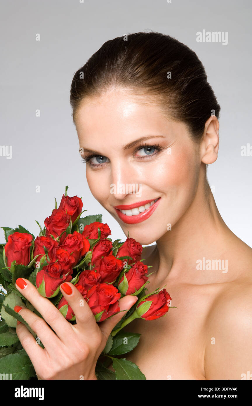 Female beauty model smelling roses Stock Photo - Alamy