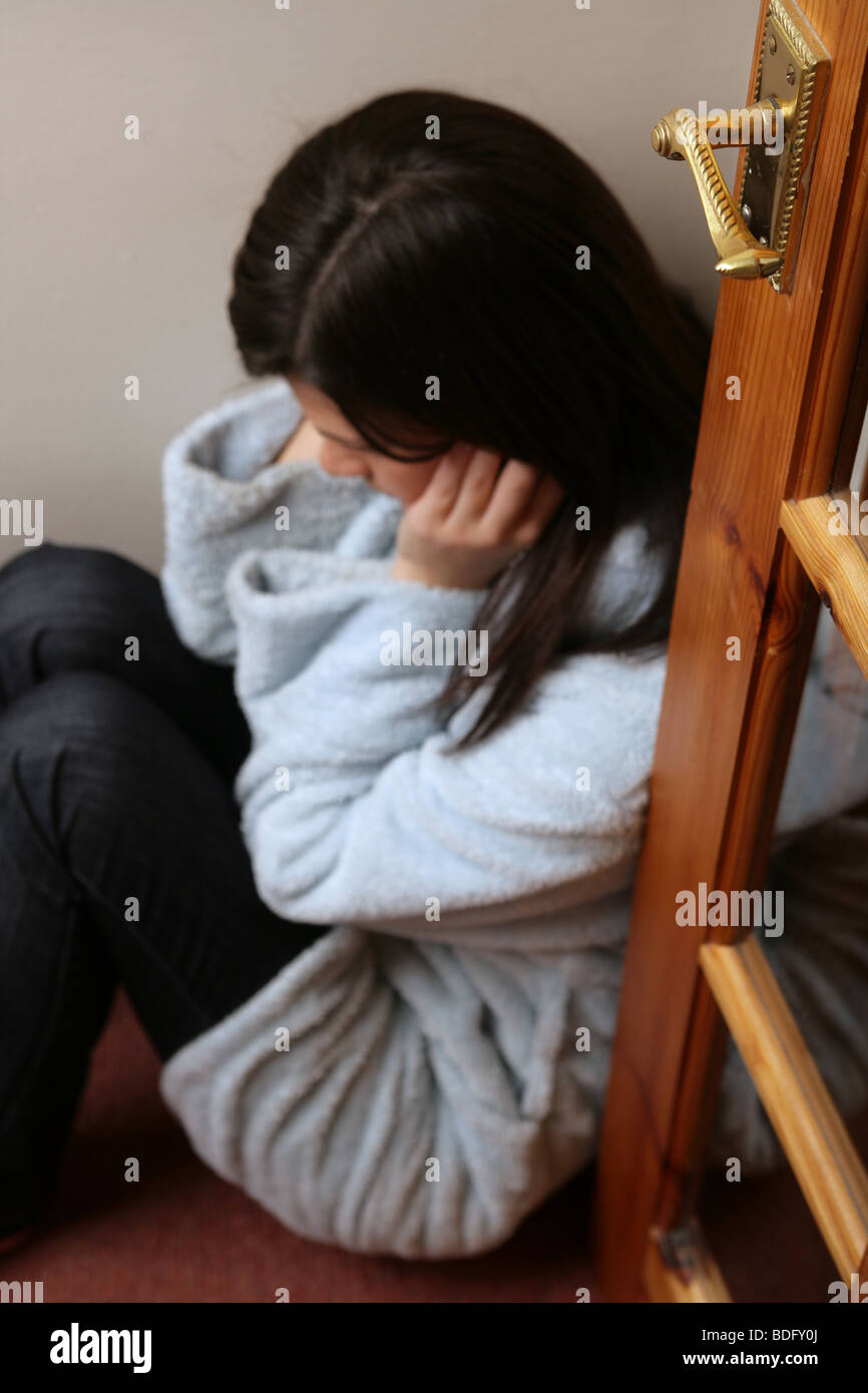 Scared woman alone dark room hi-res stock photography and images - Alamy