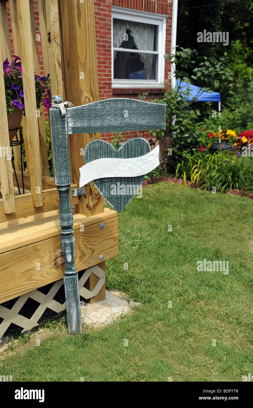 Home entrance sign with heart and banner on a post Stock Photo - Alamy