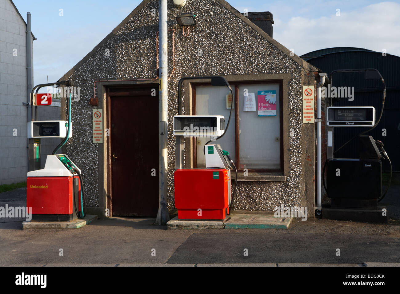 petrol and diesel fuel pumps outside traditional small garage in an ...
