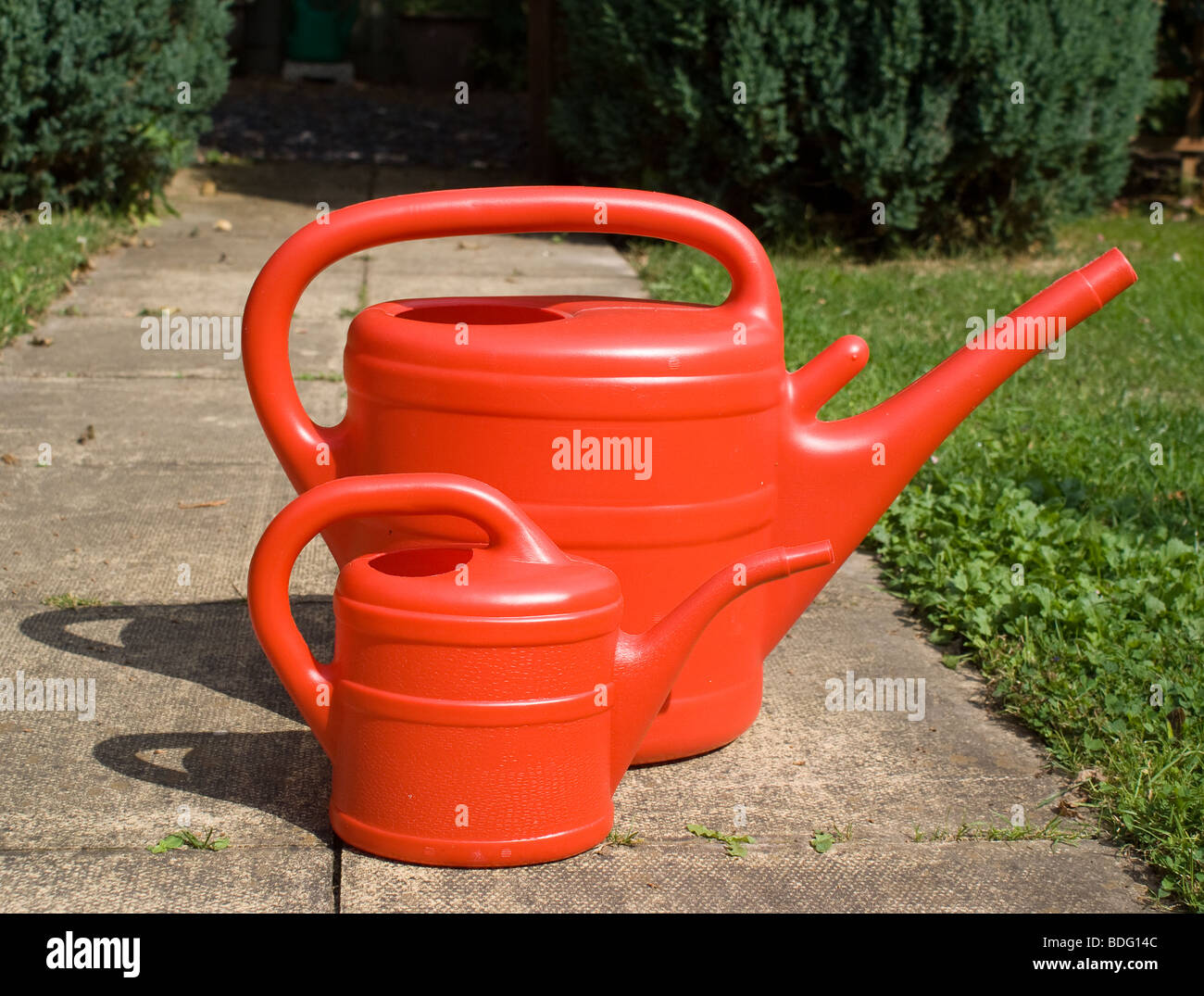 red watering cans Stock Photo - Alamy