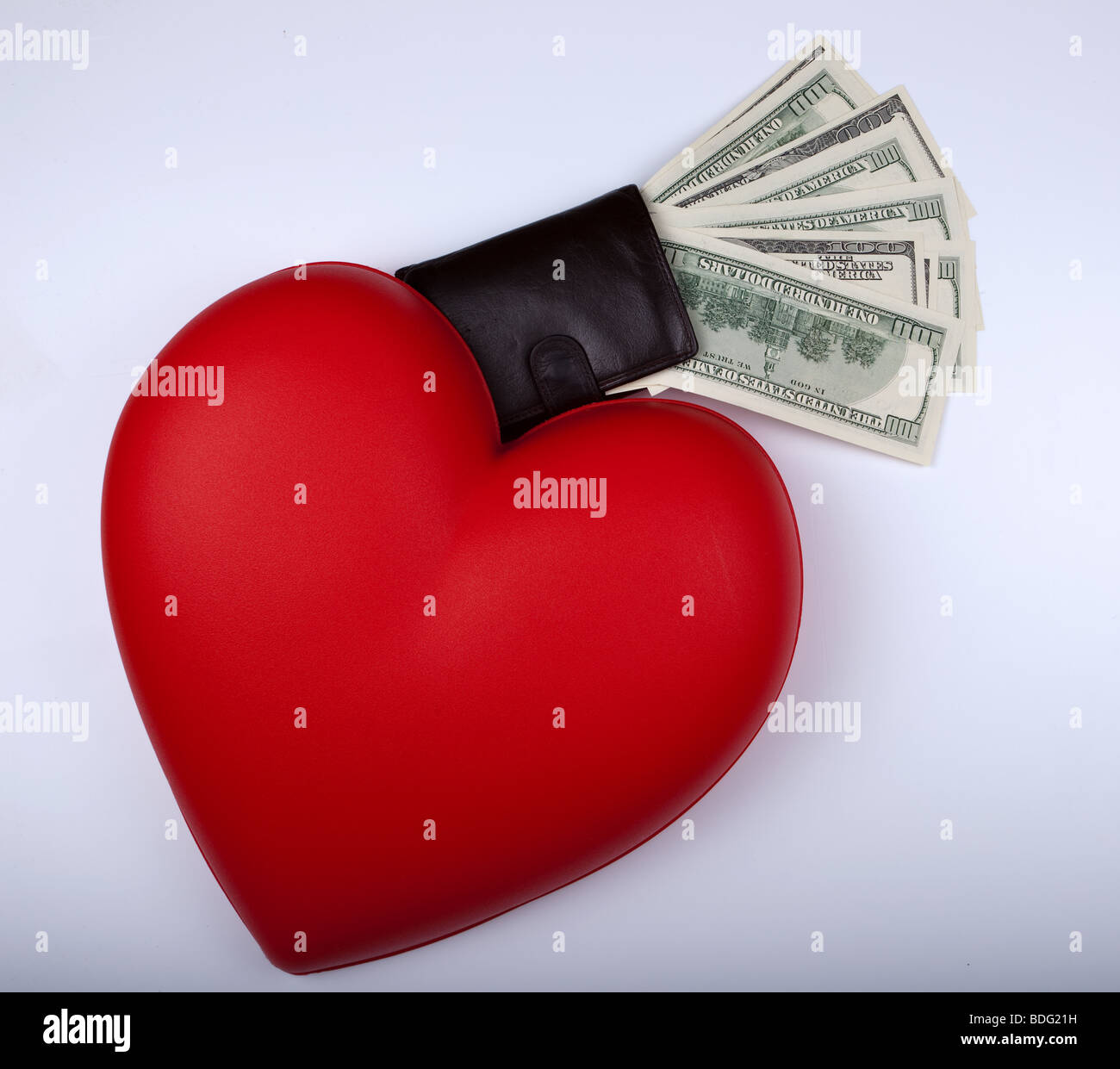 Red plastic heart lies on a white plastic background Stock Photo - Alamy