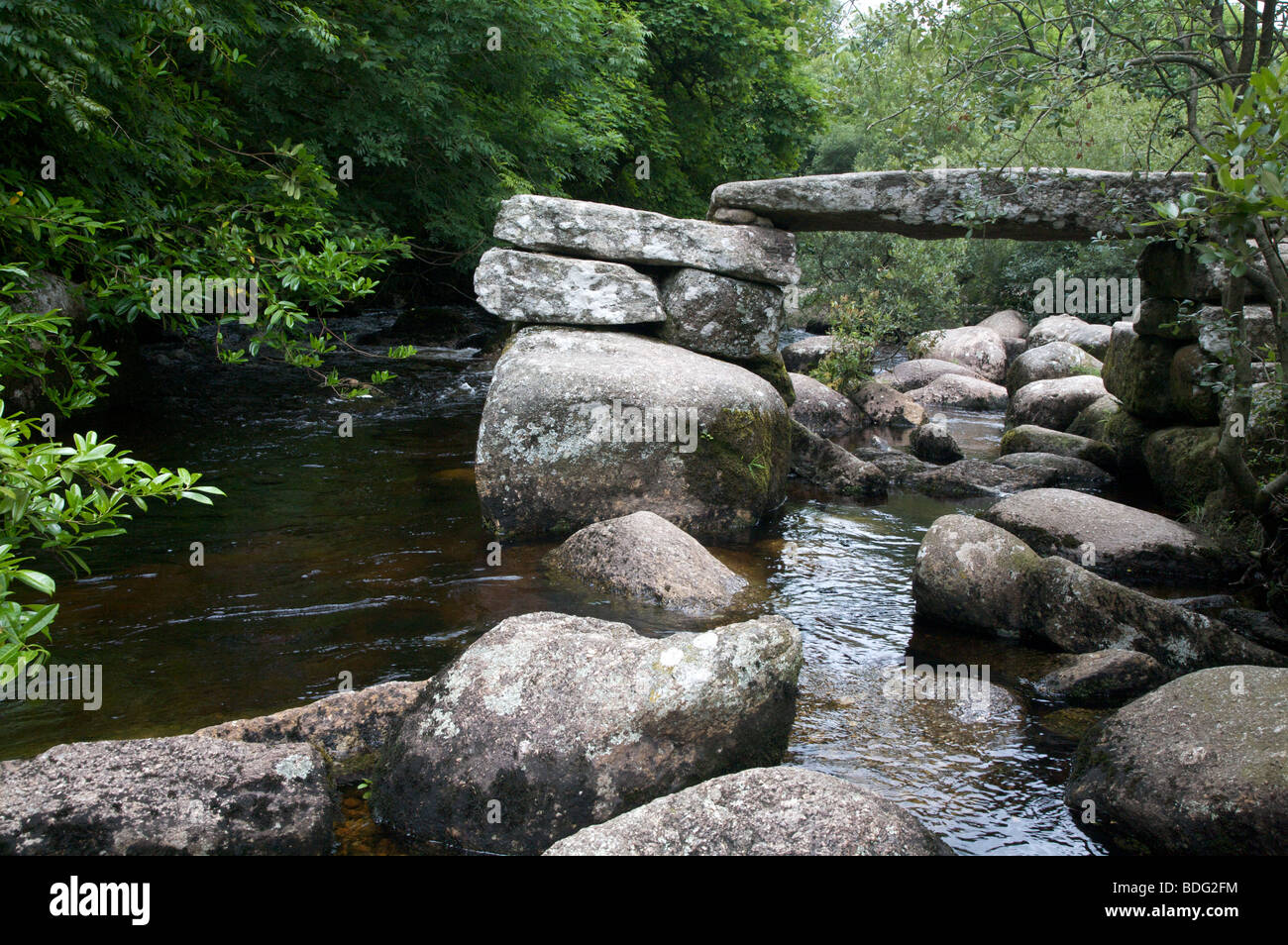 Remains of an ancient stone slab bridge over the River Dart at Dartmeet ...