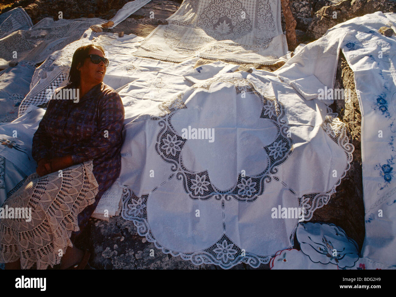 Rhodes Greece Lindos Woman Selling Table Cloths Stock Photo - Alamy