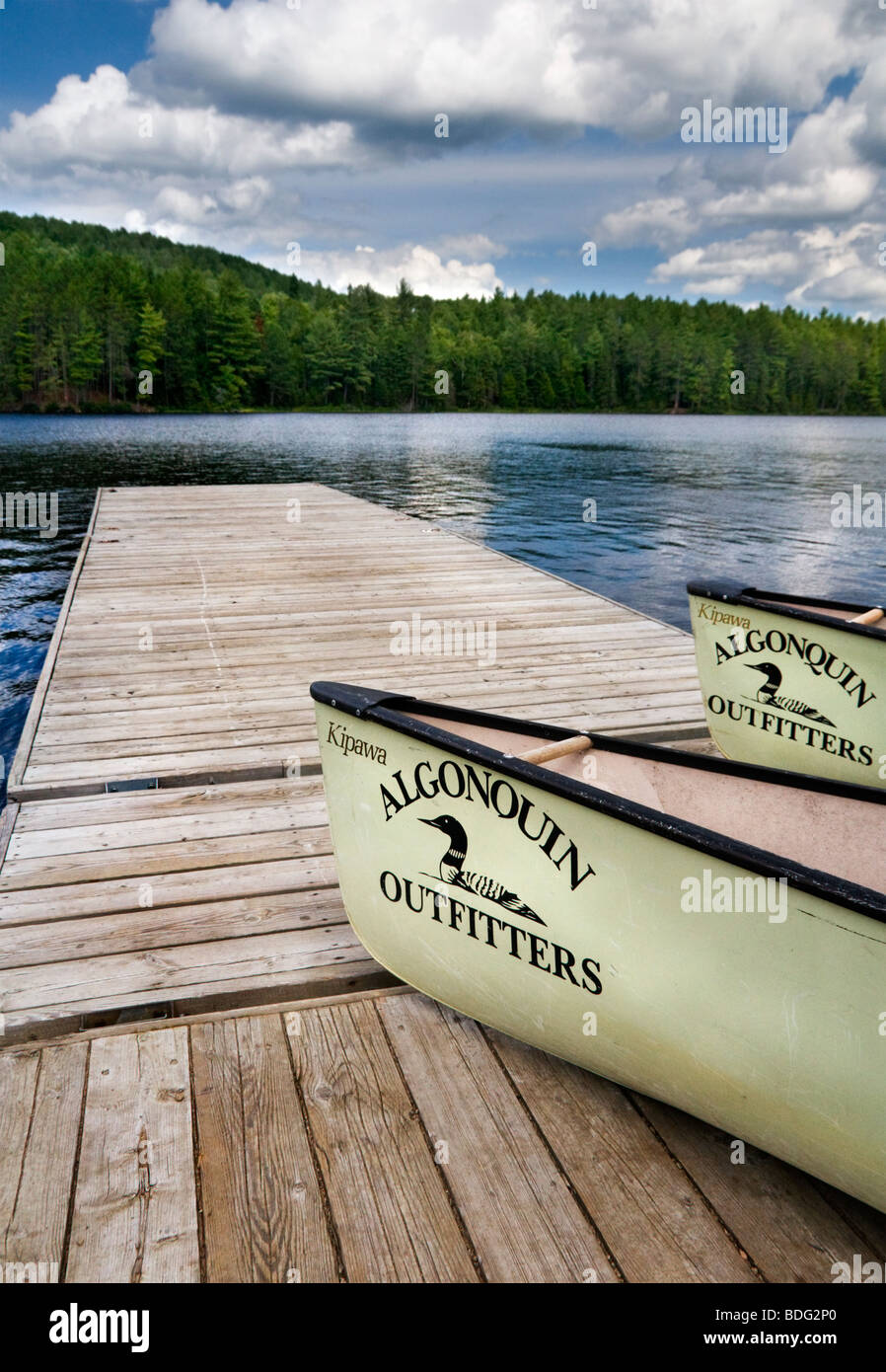 Two canoes on a wooden jetty by a lake in Algonquin Provincial Park ...